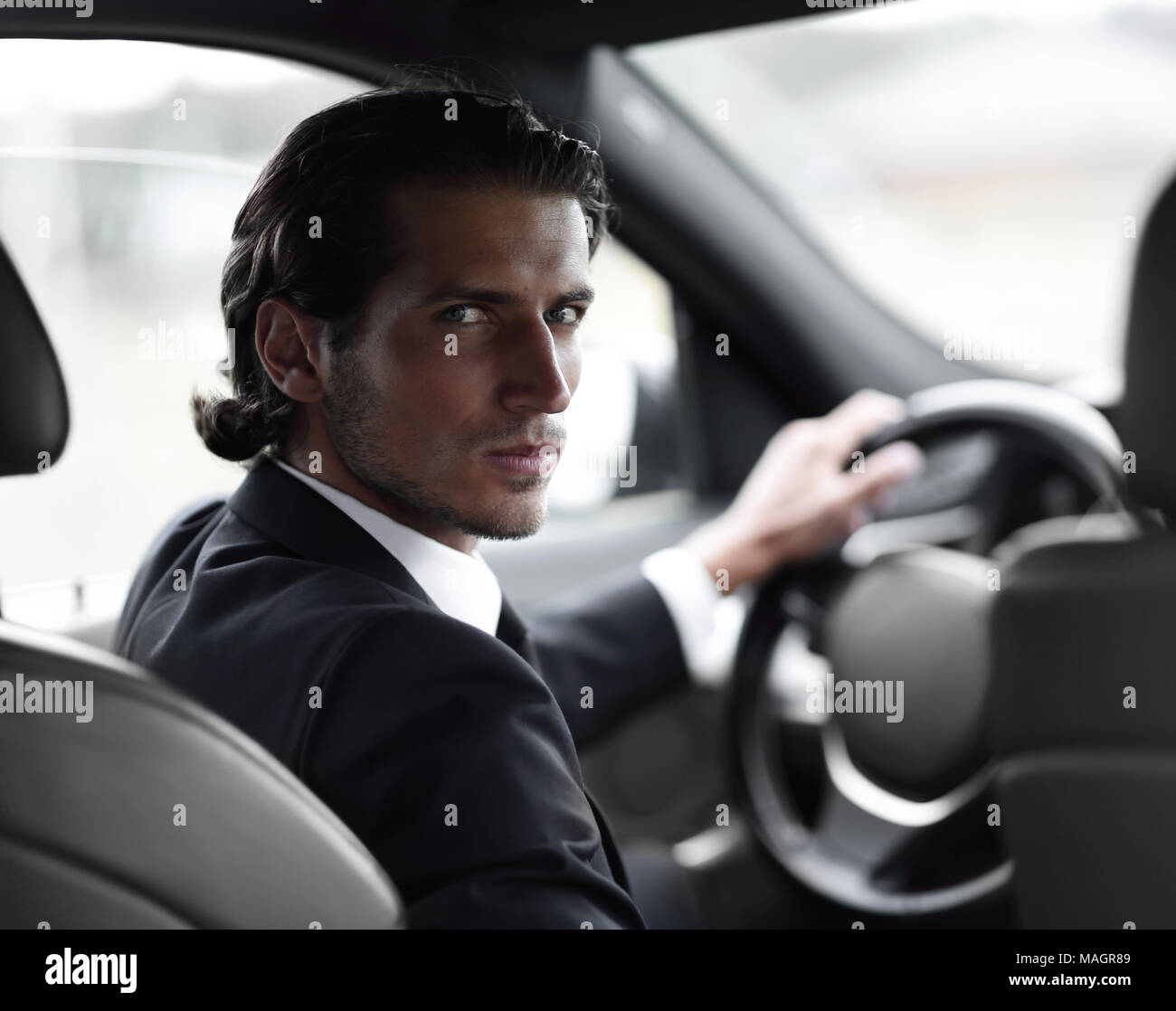 man sitting behind the wheel of a car Stock Photo - Alamy