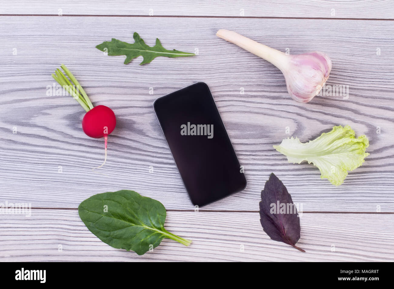Fresh vegetables, seasonings and smartphone. Fresh ingredients for ...
