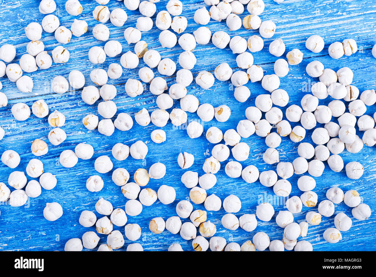 spilled many chickpeas on a blue wooden background Stock Photo - Alamy
