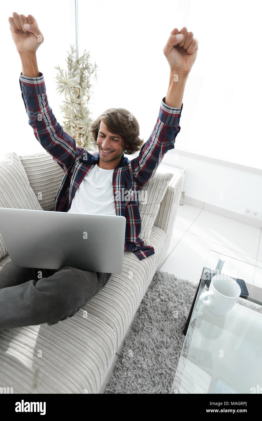 very happy guy working with laptop at home Stock Photo - Alamy