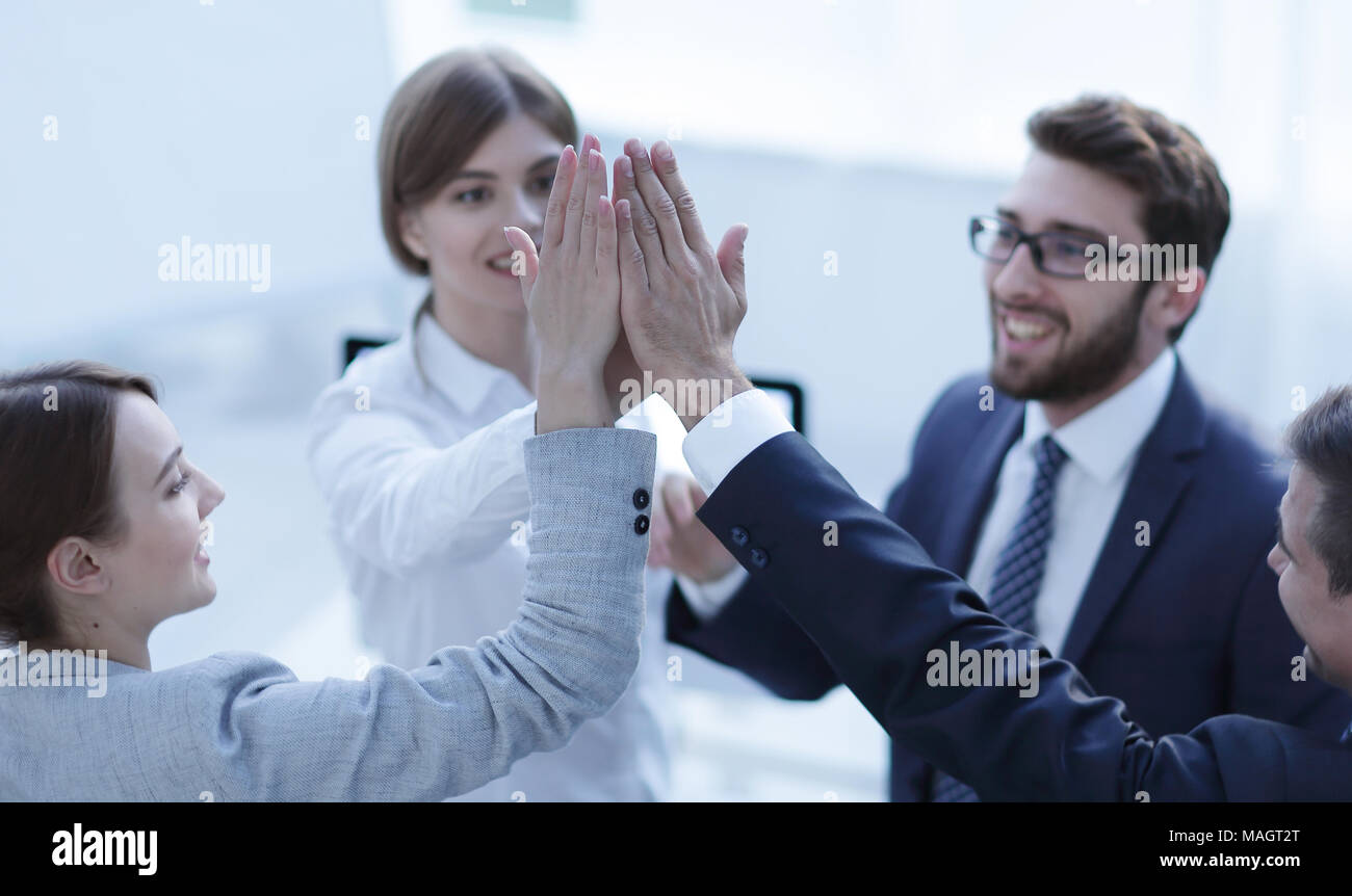 successful business team giving each other a high-five, standing in the ...