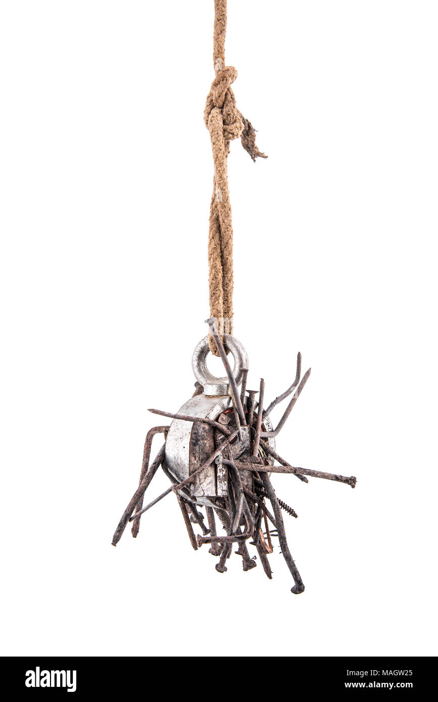 Two-way steel search magnet with rusty nails hanging on rope, isolated ...