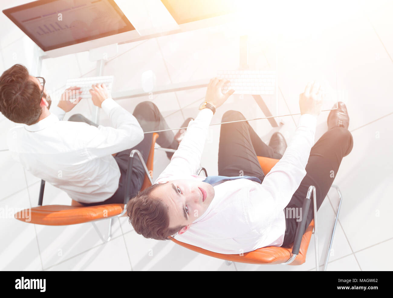Boss behind desk with employees hi-res stock photography and images - Alamy