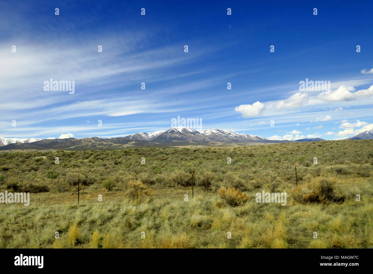 Mountain peaks with a stunning blue sky filled with stringy cirrus ...