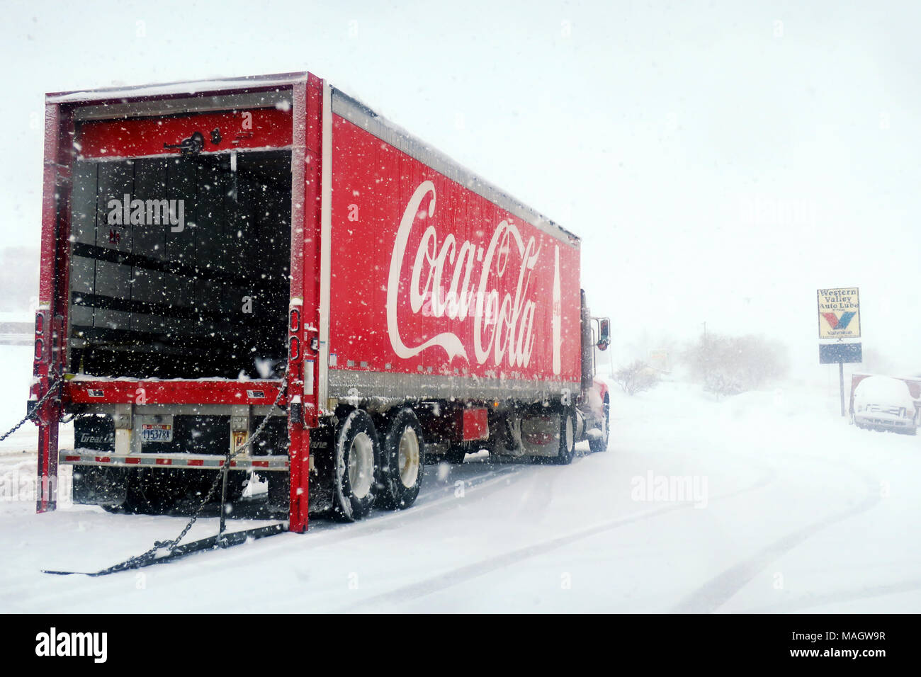 A red coca-cola truck unloading pop at a gas station in the snow Stock ...