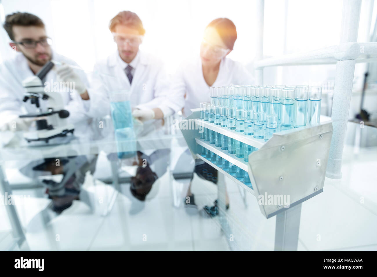 background image of scientists studying blue liquid in a flask Stock ...