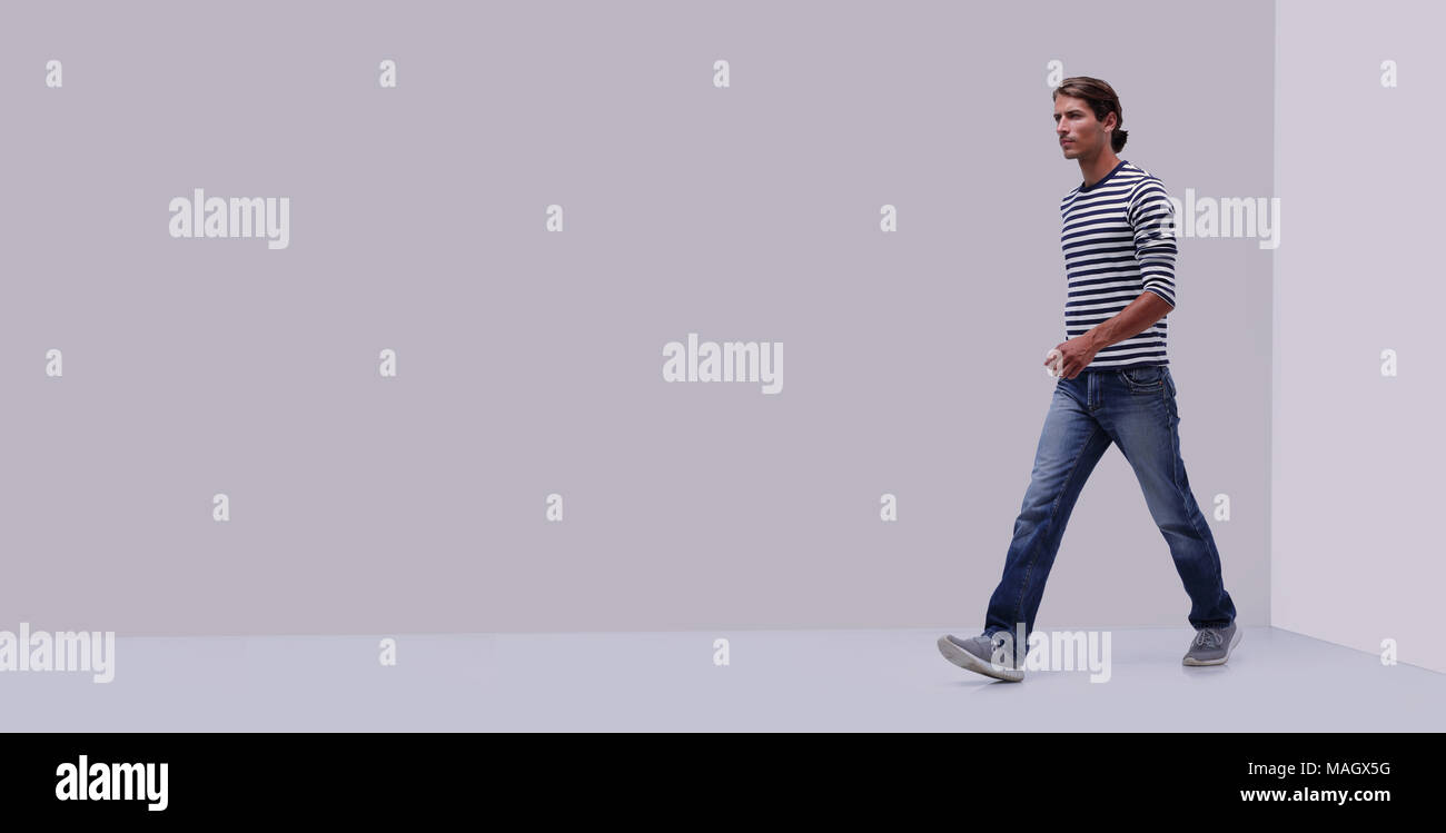 Side view.strong young man goes forward Stock Photo - Alamy