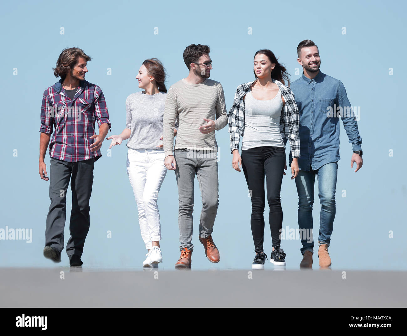 team of young people walking along the road.outdoors Stock Photo - Alamy