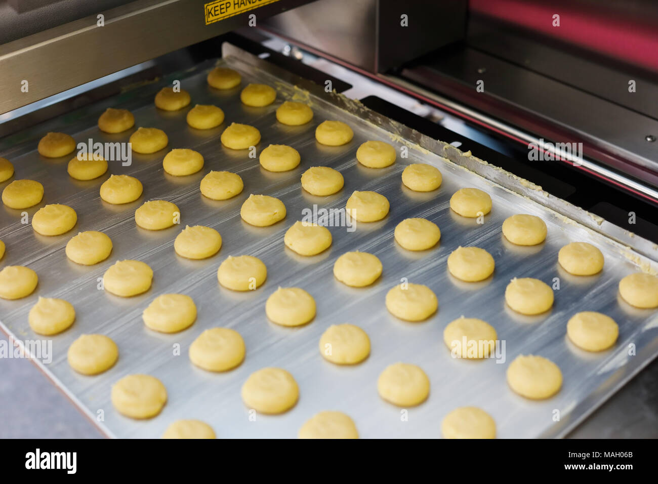 Industrial biscuit cookies manufacturing. Cookies on the tray before ...