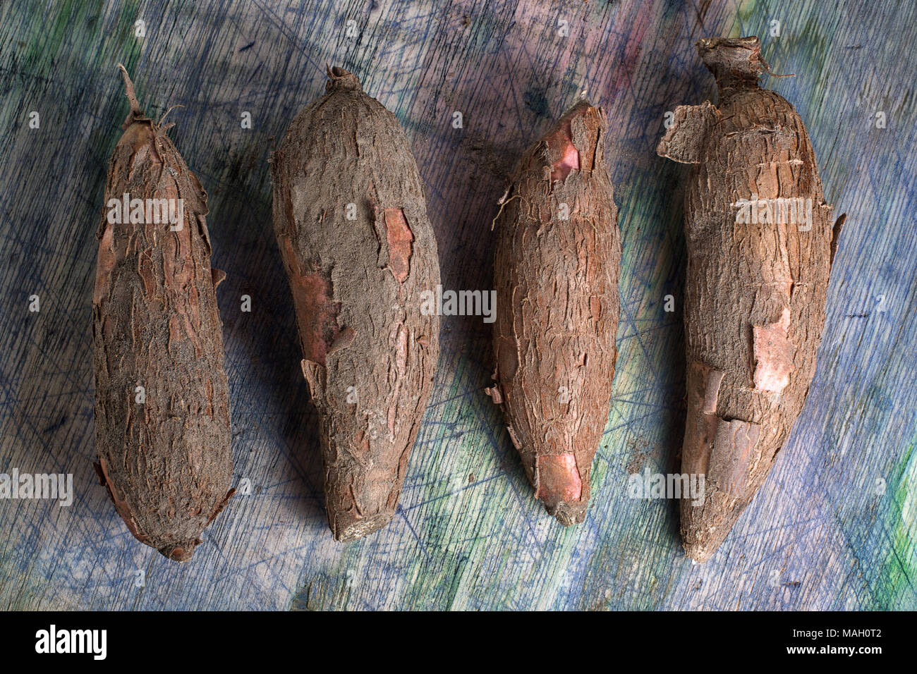 cassava roots on rustic background Stock Photo - Alamy