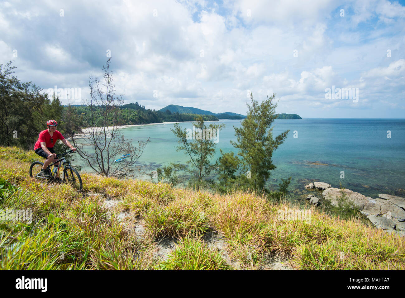 A man cycling along a headland, Kudat, Sabah, Malaysia, Borneo Stock ...