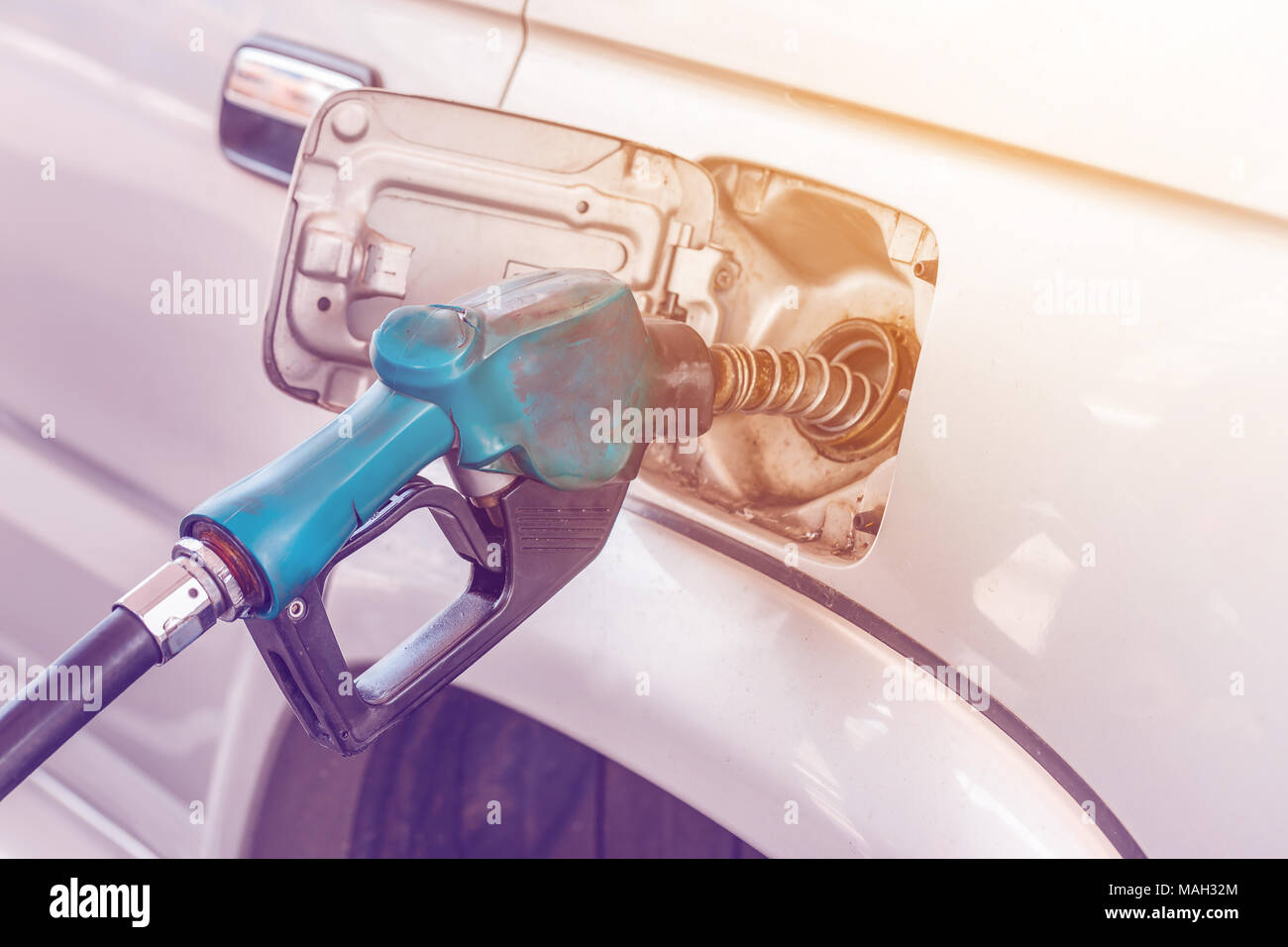 Closeup of pumping gasoline fuel into car tank with light effect Stock ...
