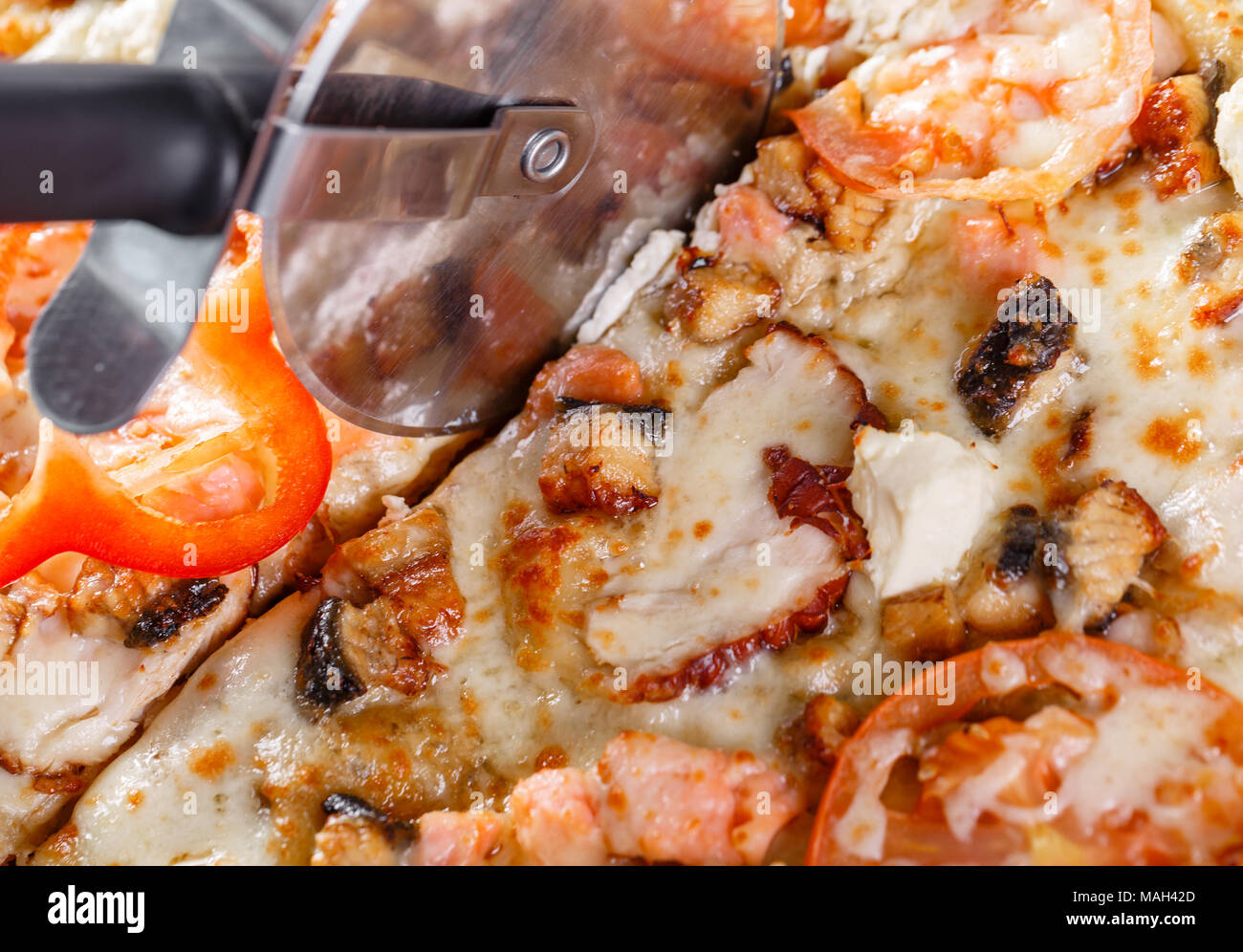 Italian kitchen and cooking concept - cook with cutter cutting pizza to ...