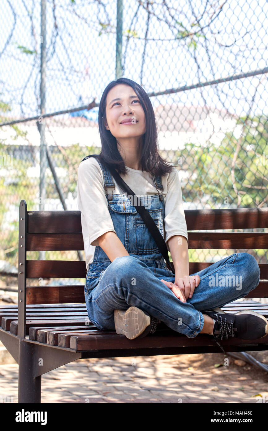 Chinese woman resting on the bench Stock Photo - Alamy