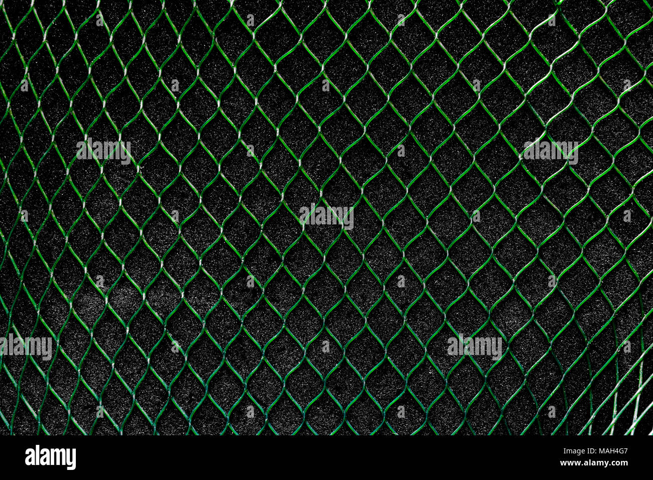 Green, vertical net on the black, soft background surface Stock Photo ...
