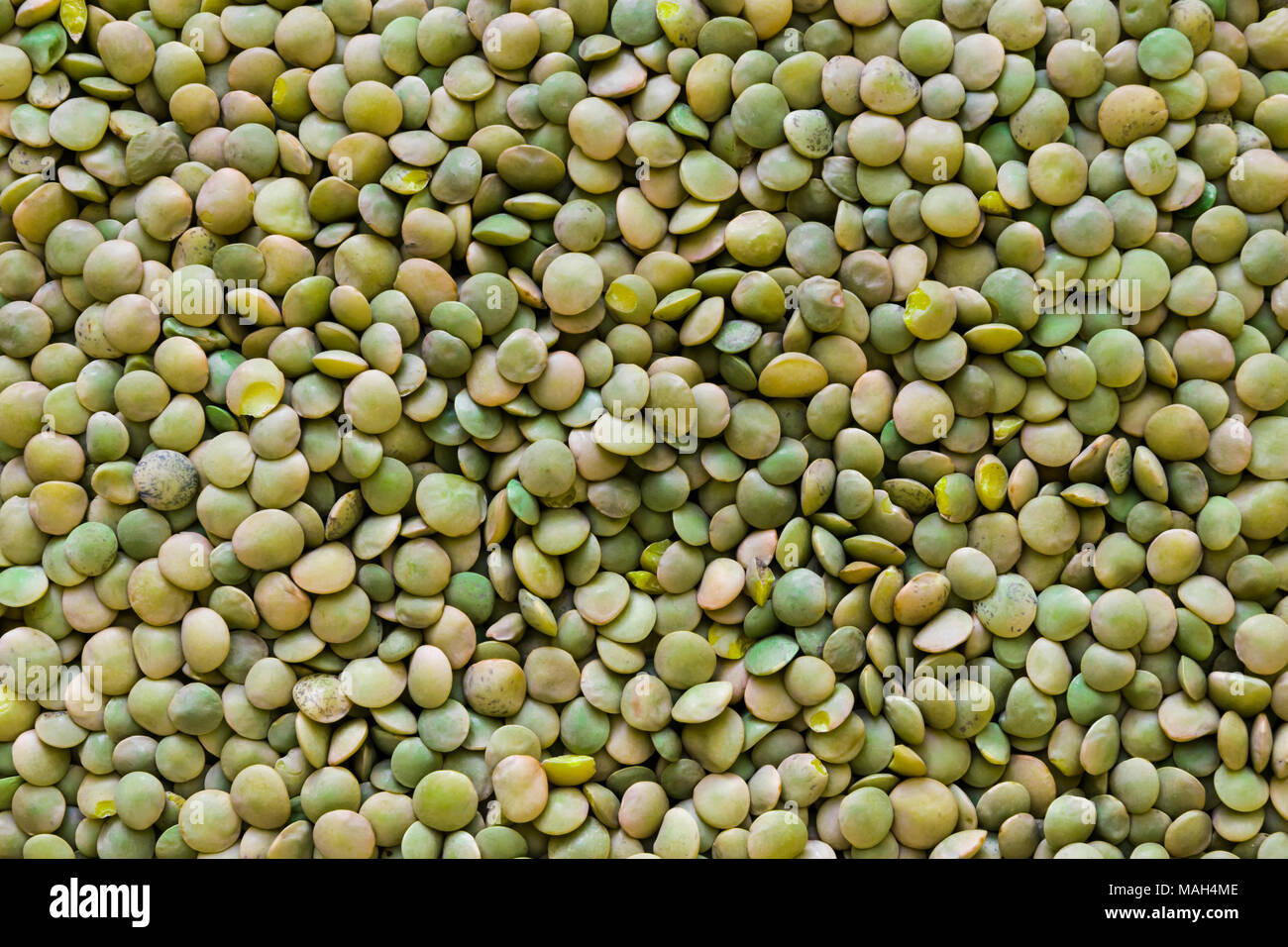 Pile of green lentil grains background surface texture Stock Photo - Alamy