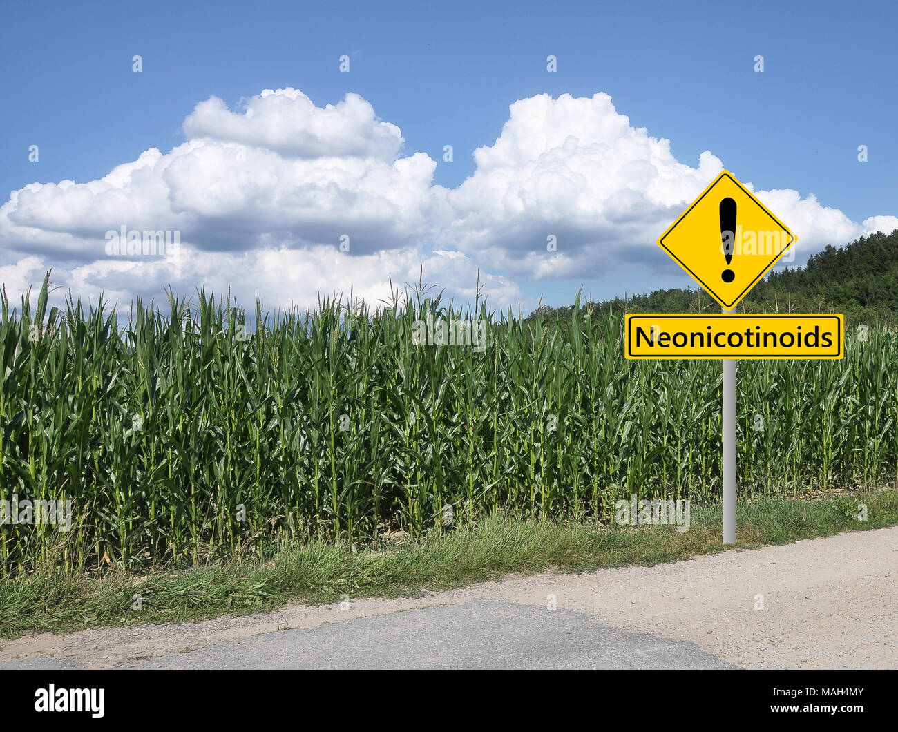 Warning sign neonicotinoids in front of maize field Stock Photo - Alamy