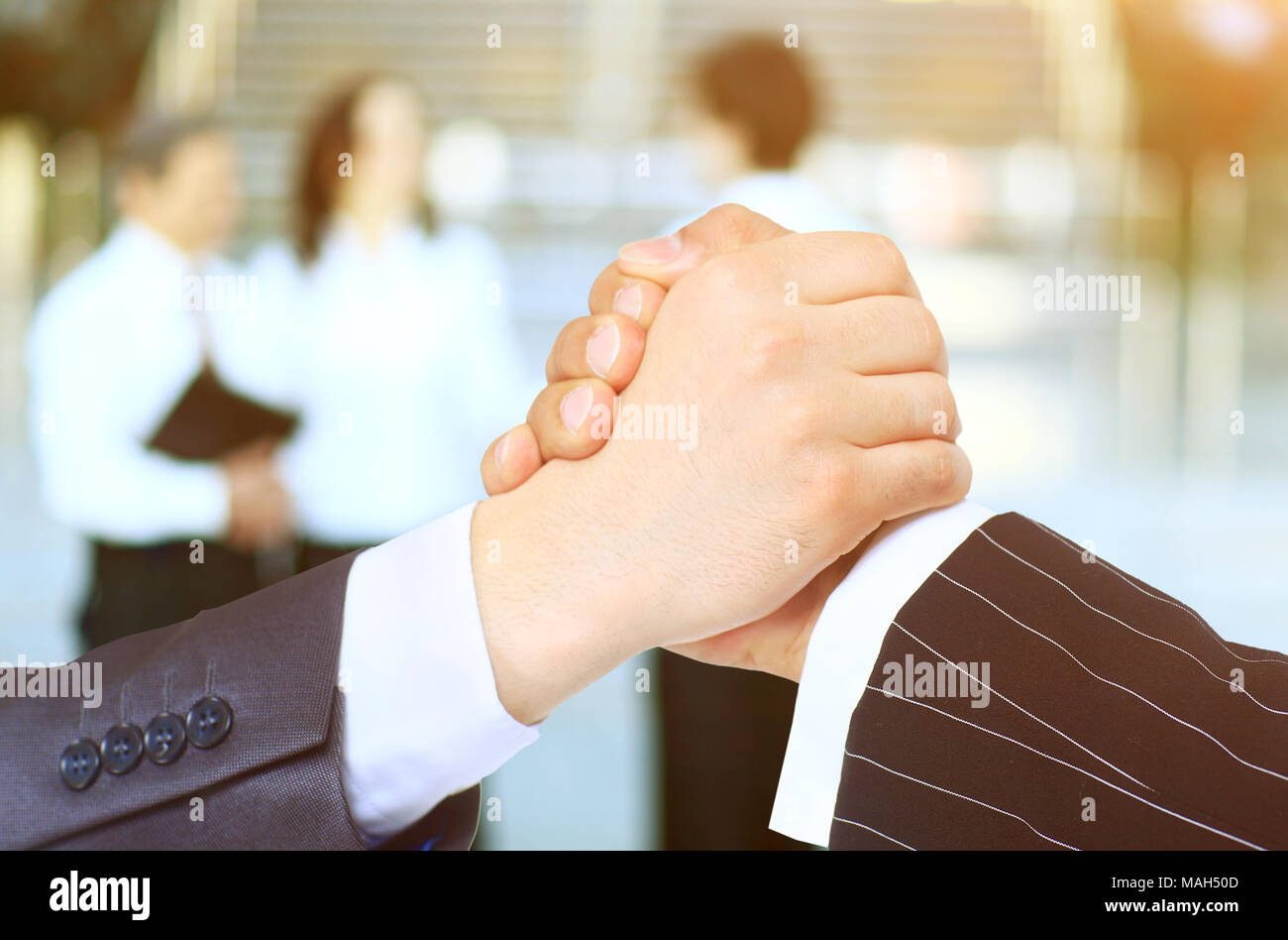 close-up of confident business handshake on blurred office background ...