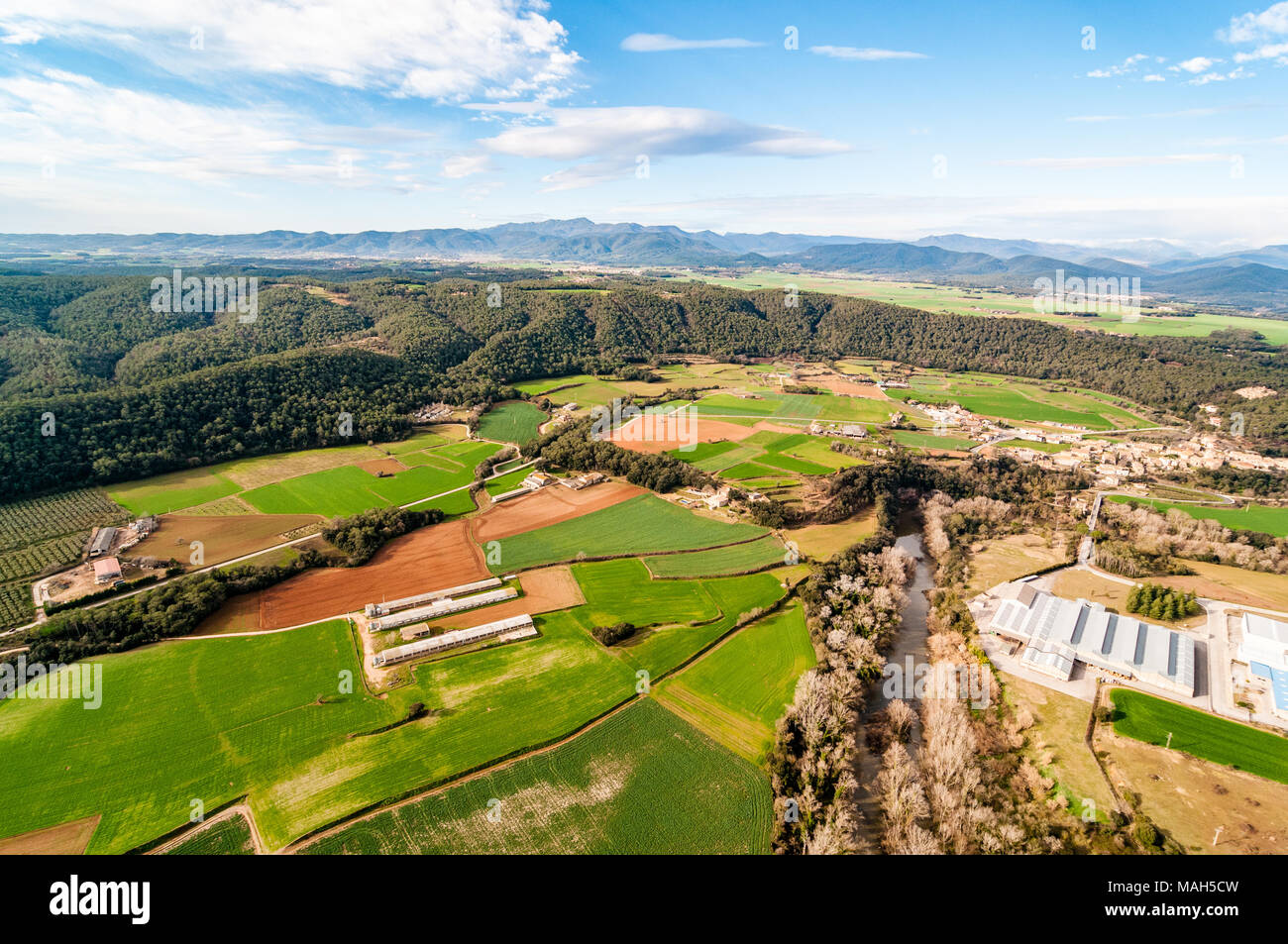 aerial view of crop fields and industrial park with forest claps, some ...