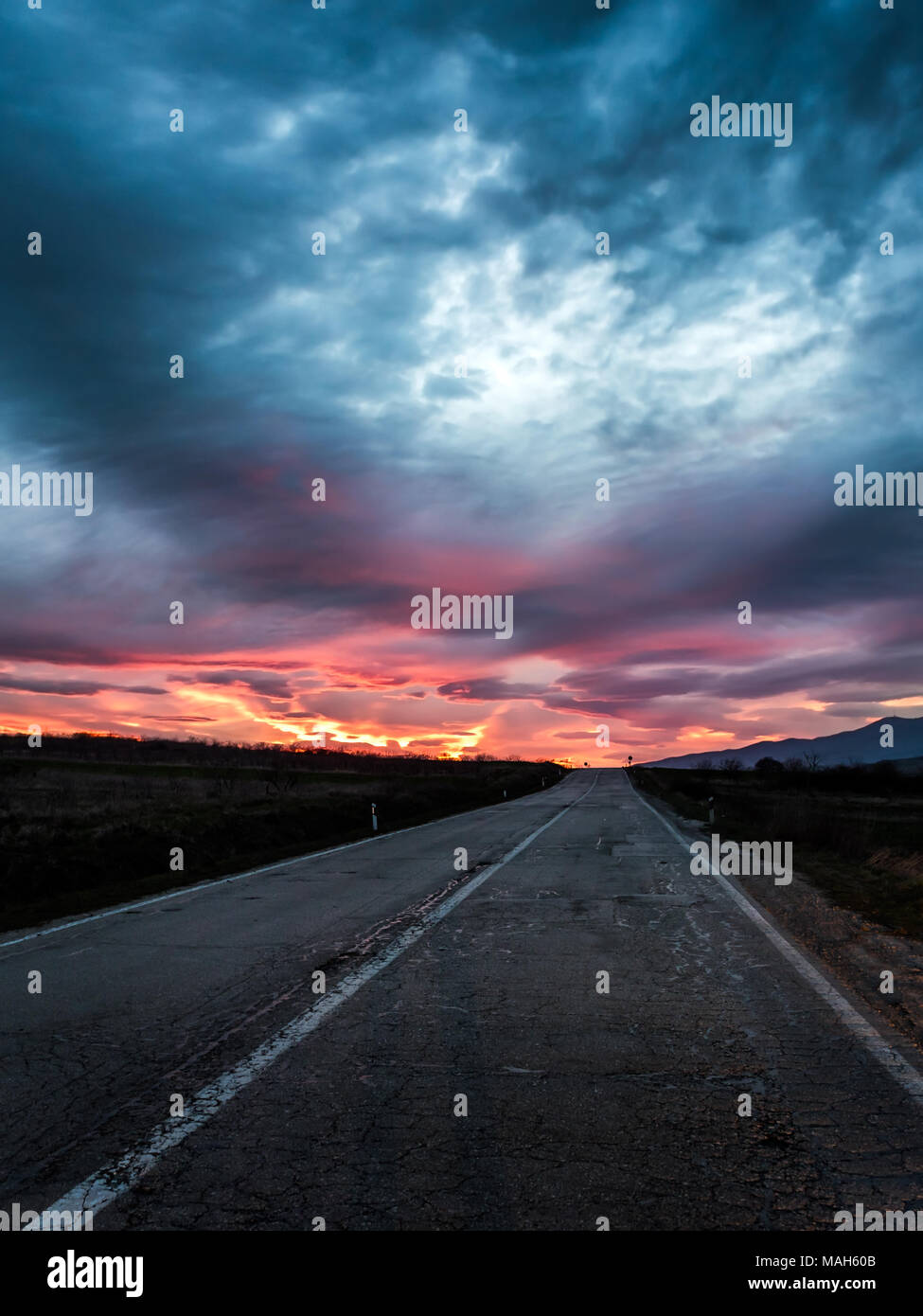 Straight highway road to a dramatic fiery sunset near twilight Stock ...