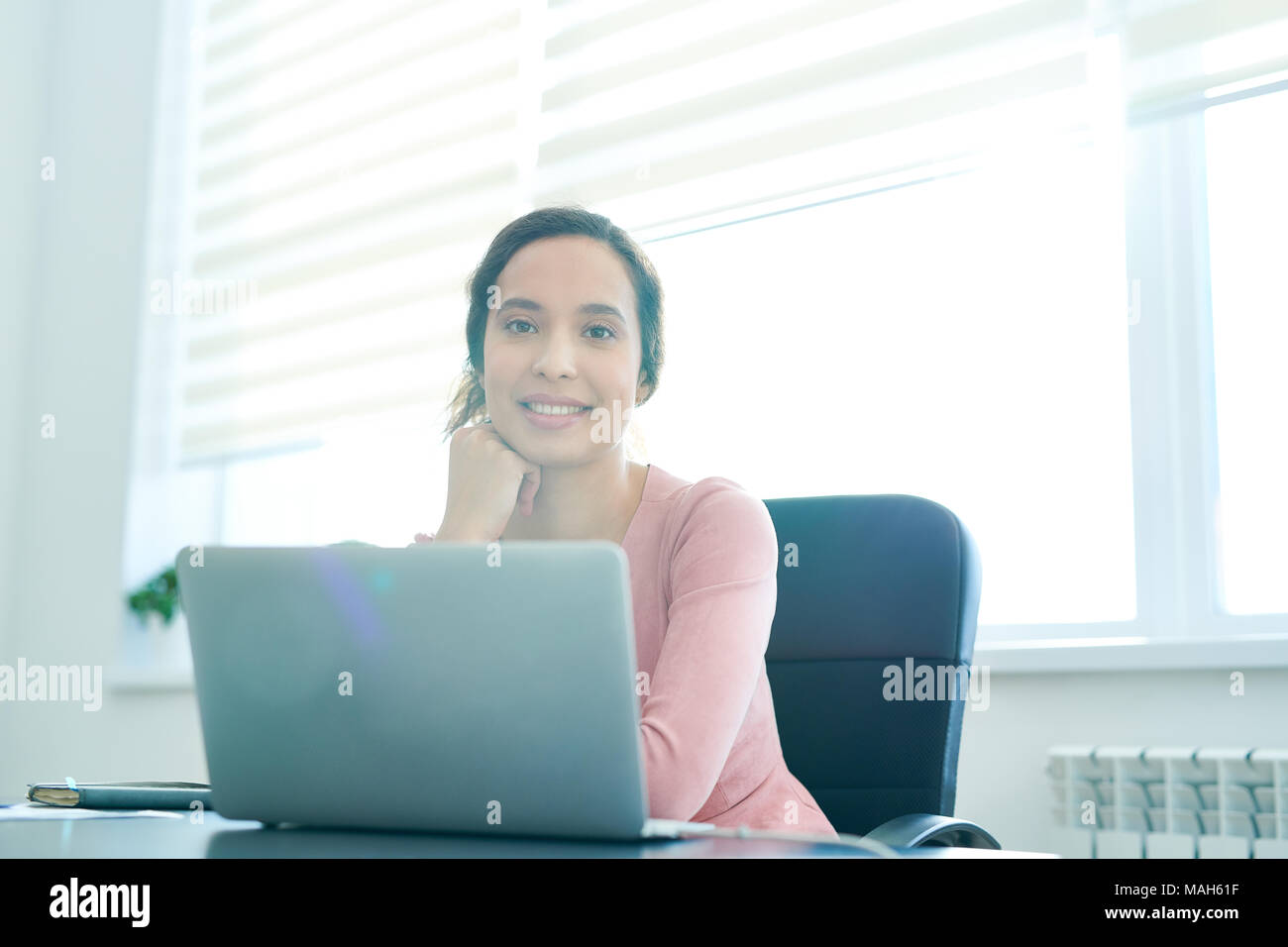 Happy Hispanic office manager Stock Photo - Alamy