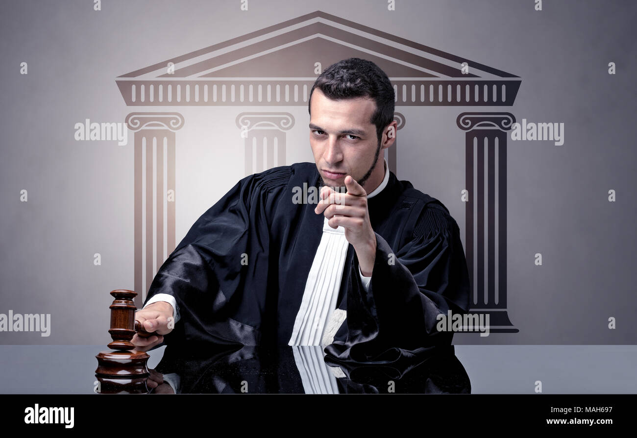 Young judge in front of a courthouse symbol making decision Stock Photo ...