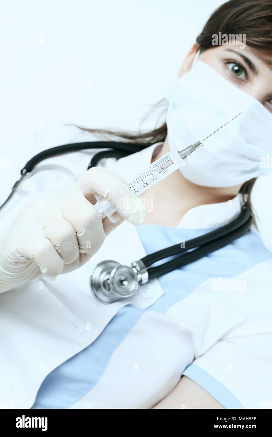 Medical needle in female doctor hands Stock Photo - Alamy