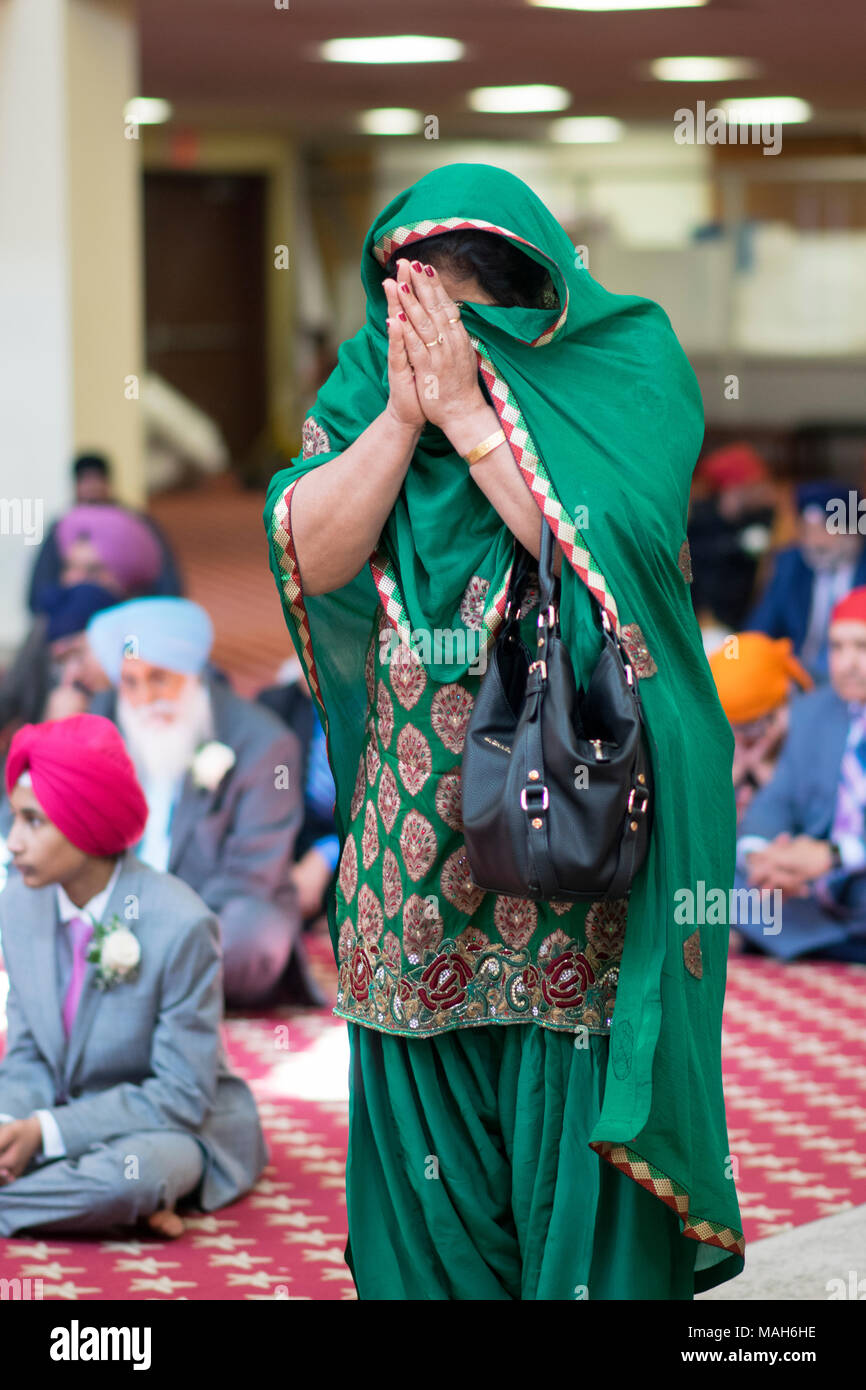 Portrait of a Sikh woman meditating at a wedding at the Gurdwara Sikh ...