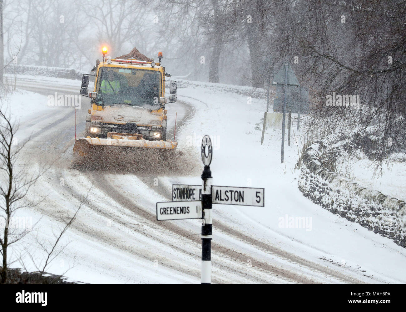 A snowplough clears a road in nenthead hi-res stock photography and ...