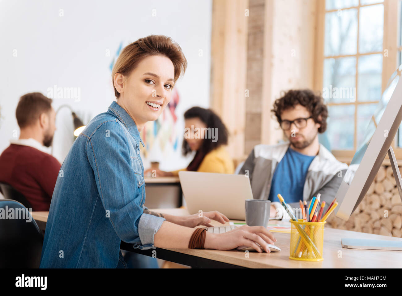 Inspired woman doing her work on the computer Stock Photo - Alamy