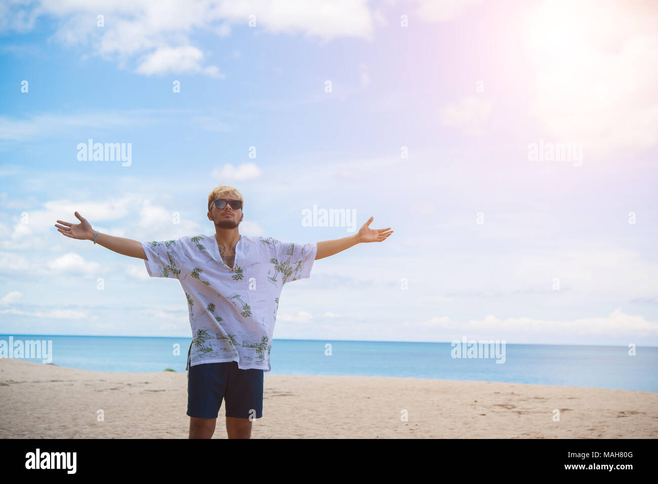Man relaxing at beach enjoying summer freedom with open arms Stock ...