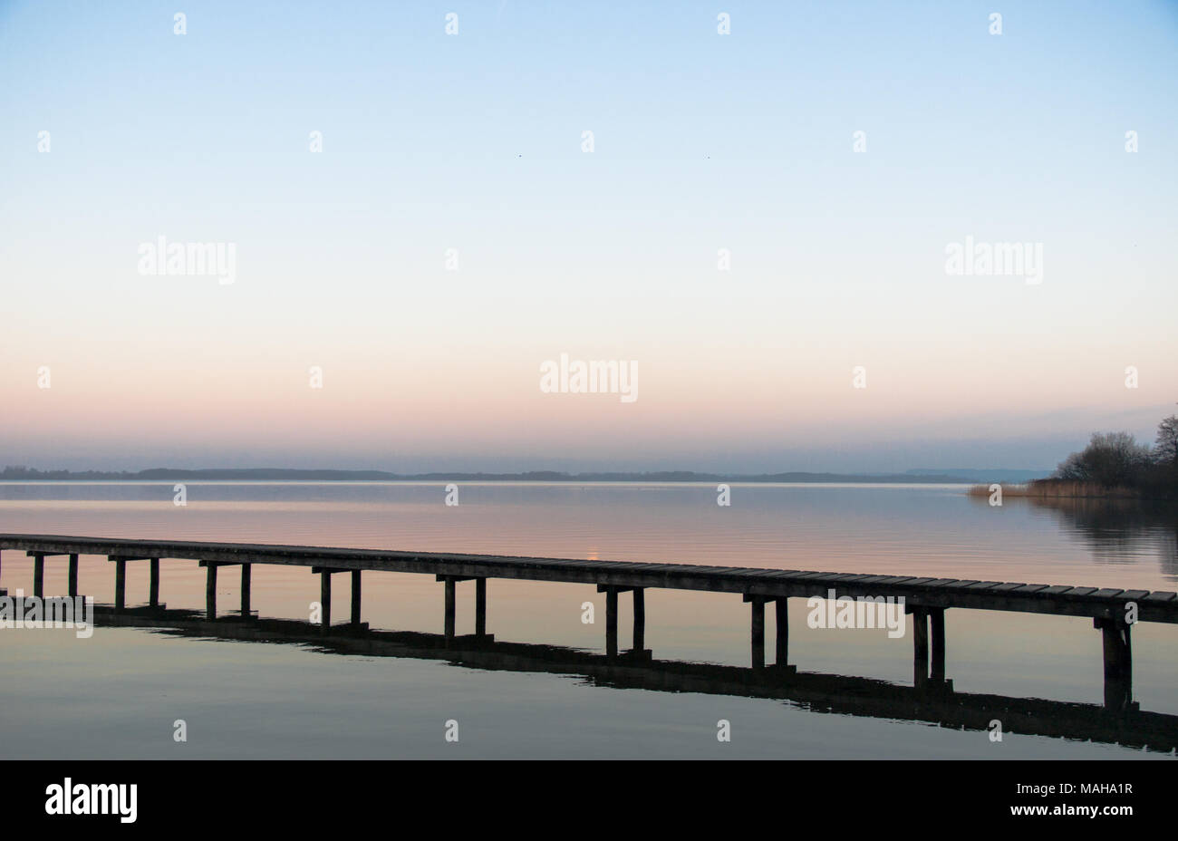 Panorama, footbridge, and quiet scene on the lake in the north, Germany ...