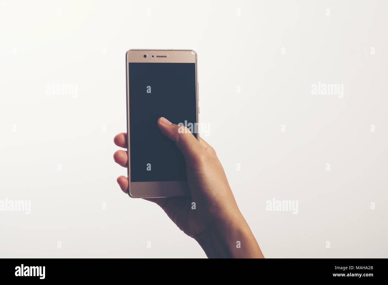 Close Up of a woman holding on mobile phone isolated on white ...