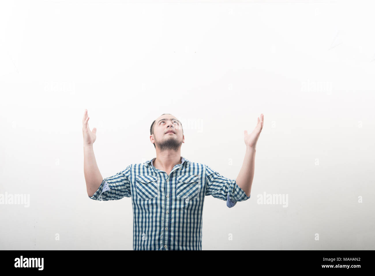 Portrait of young handsome man hands up isolated on white background ...