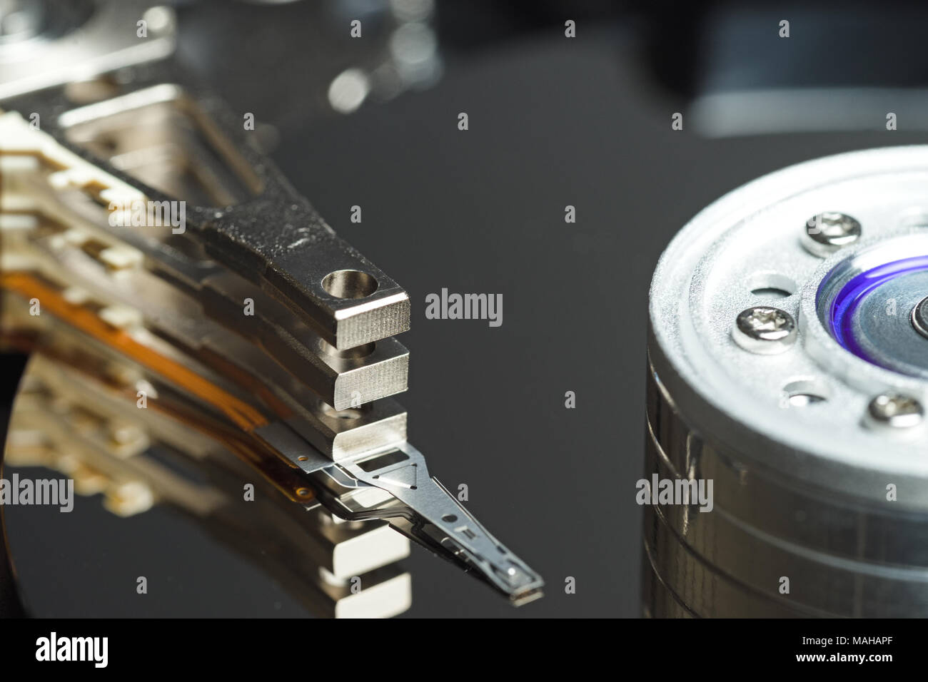Hard disk drive inside close-up, spindle, actuator arm, read write head ...