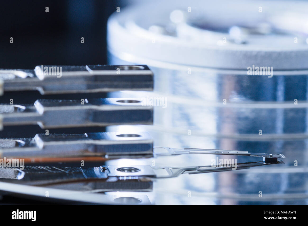 Hard disk drive inside close-up, spindle, actuator arm, read write head ... Hard disk drive inside close-up, spindle, actuator arm, read write head ...