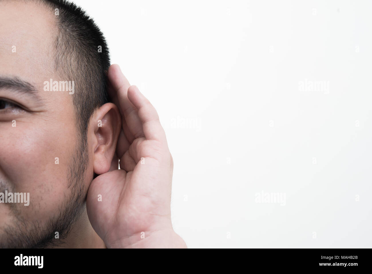 Close up of Man holds his hand near his ear and listening something ...