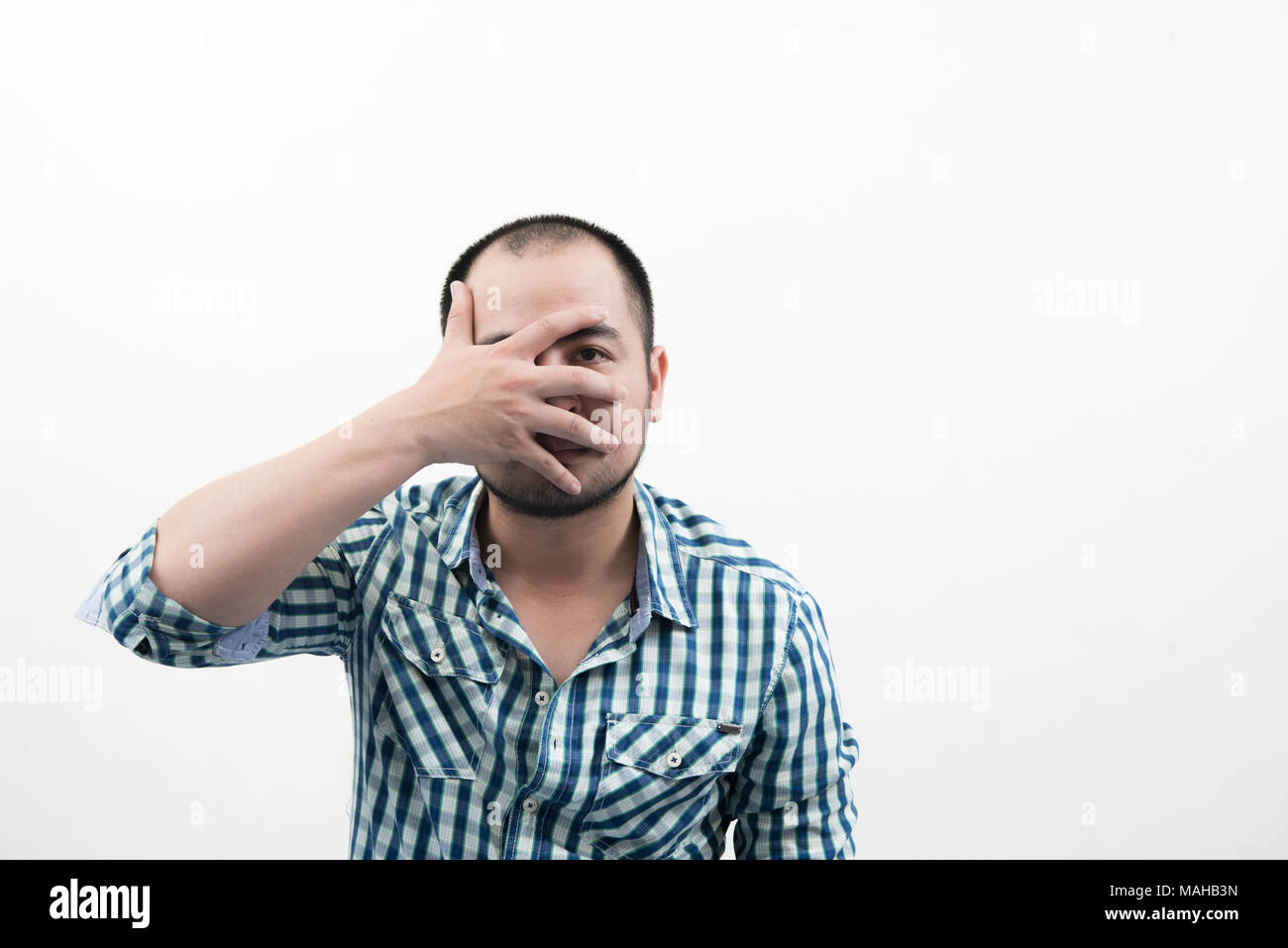 Man covering his face isolated on white background Stock Photo - Alamy