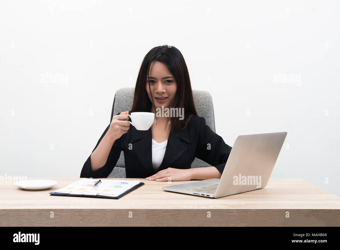 Young asian pretty business woman with notebook in the office isolated ...