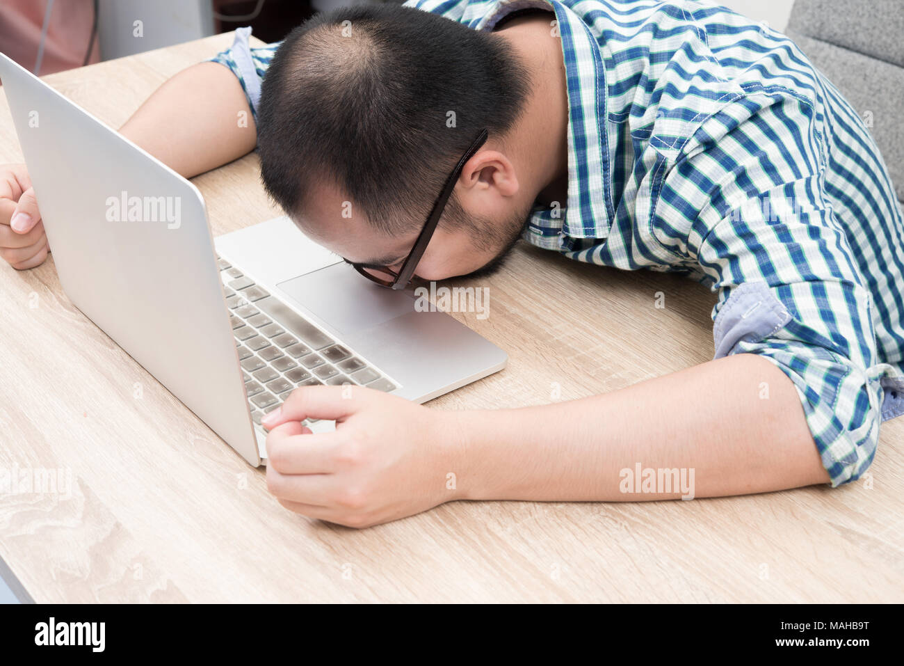 Portrait of businessman sitting behind table tired fall asleep at ...