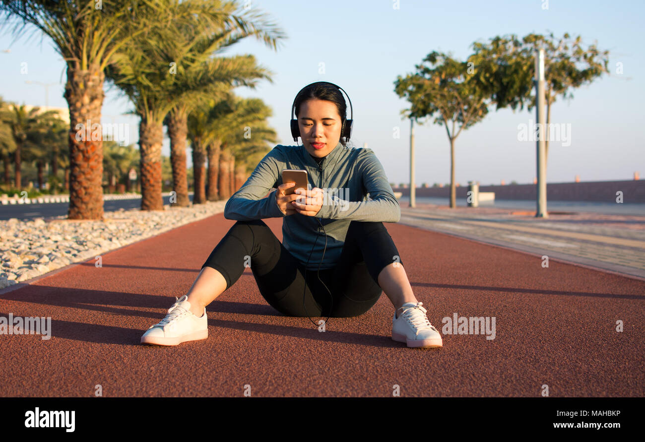 Girl taking a break from workout on a running track Stock Photo - Alamy