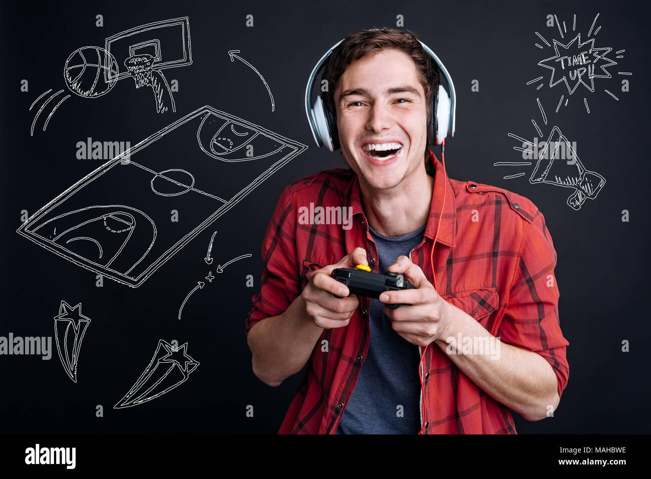 Happy man laughing while playing video games Stock Photo - Alamy