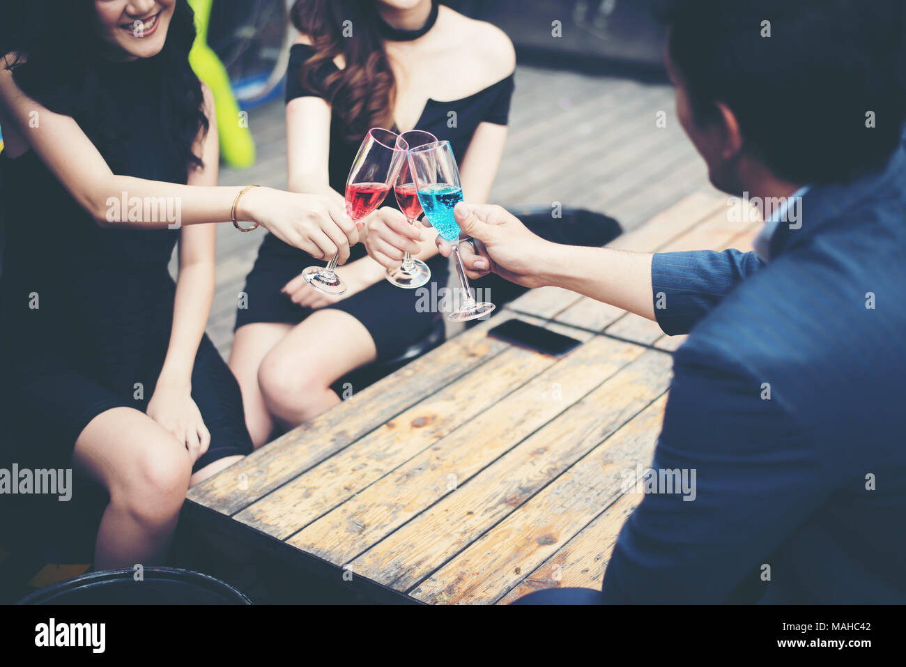Portrait of happy young friends having fun and drinking together Stock ...