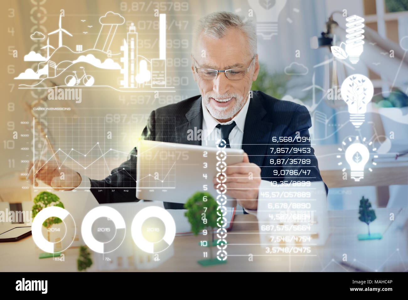 Positive engineer looking at the screen of a tablet and feeling ...