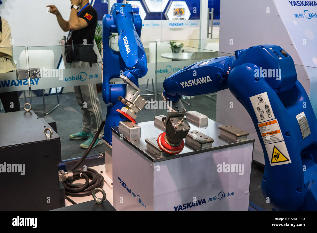 Yaskawa industrial robots, robot arms polishing metal at a ...