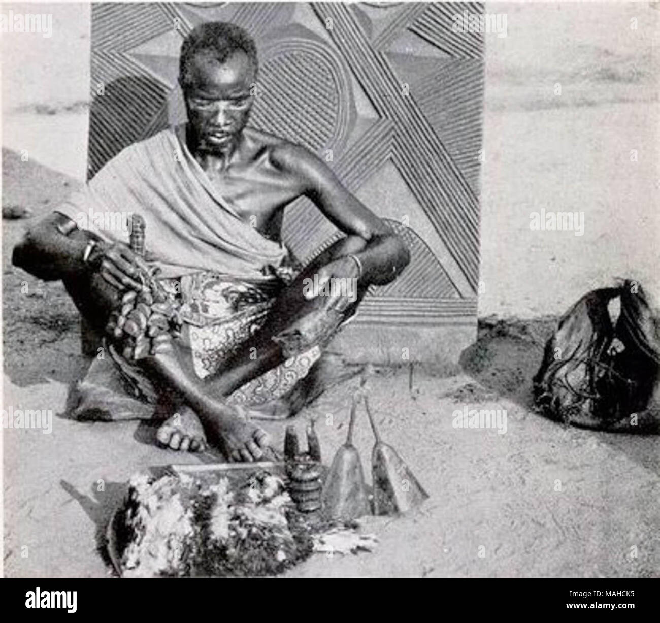 A dibia from the early 20th century with tools of his practice ...