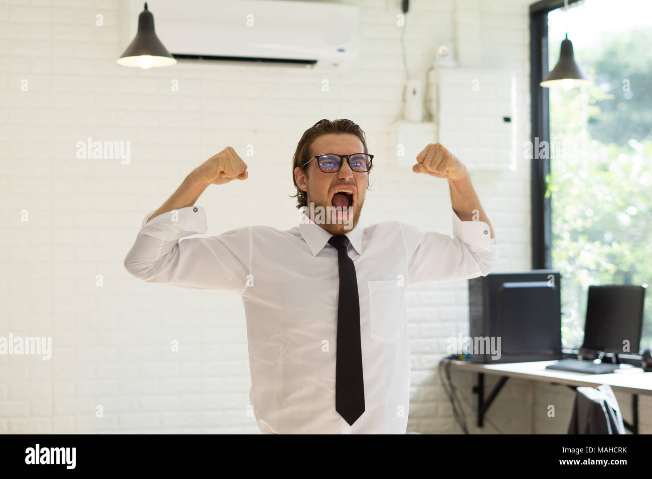 Strong business man flexing muscle hi-res stock photography and images ...