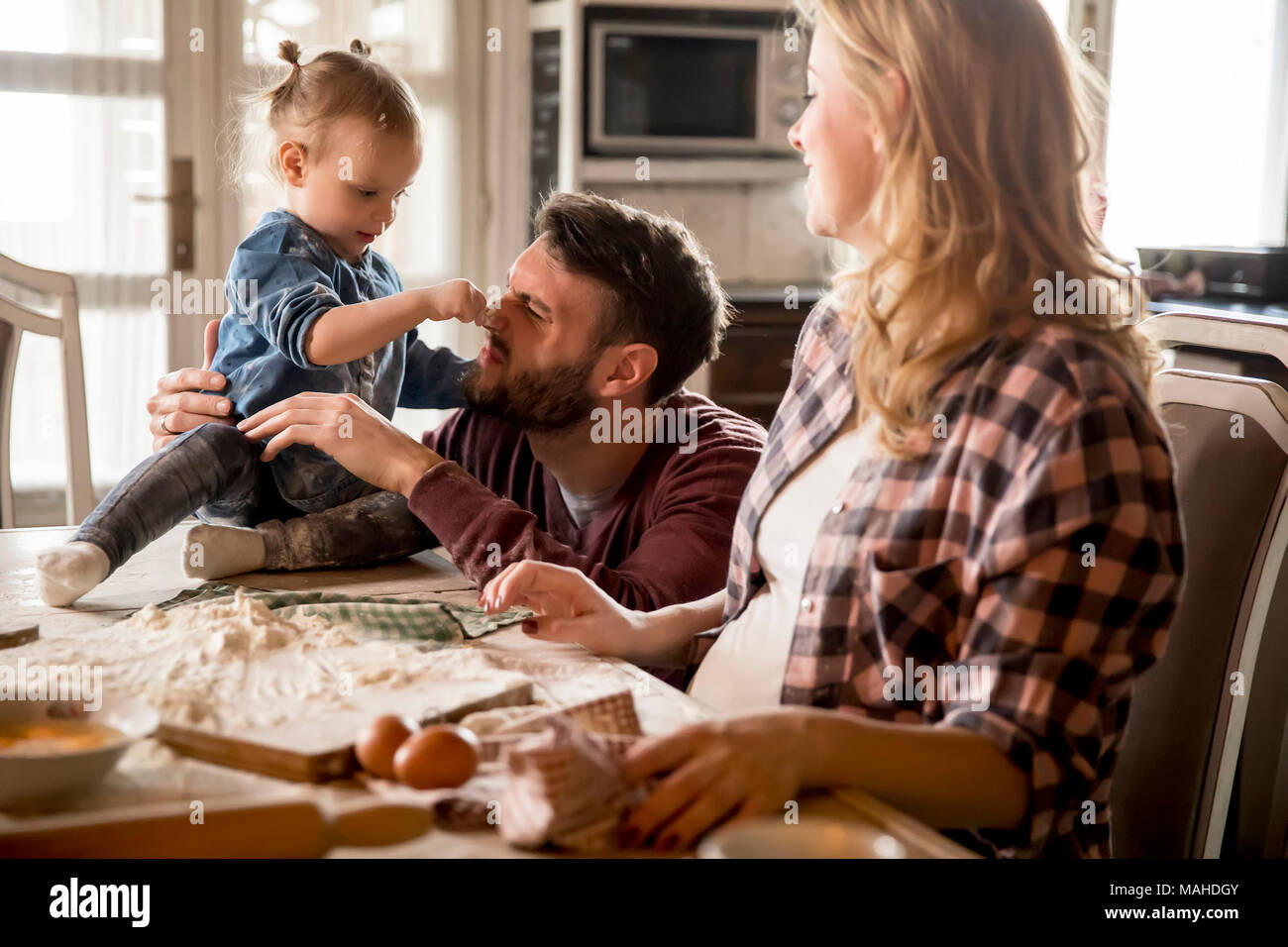 Happy family making pasta in the kitchen at home Stock Photo - Alamy