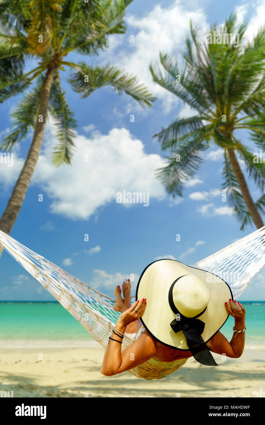 Woman sunbathing in the caribbean on the beach hi-res stock photography ...
