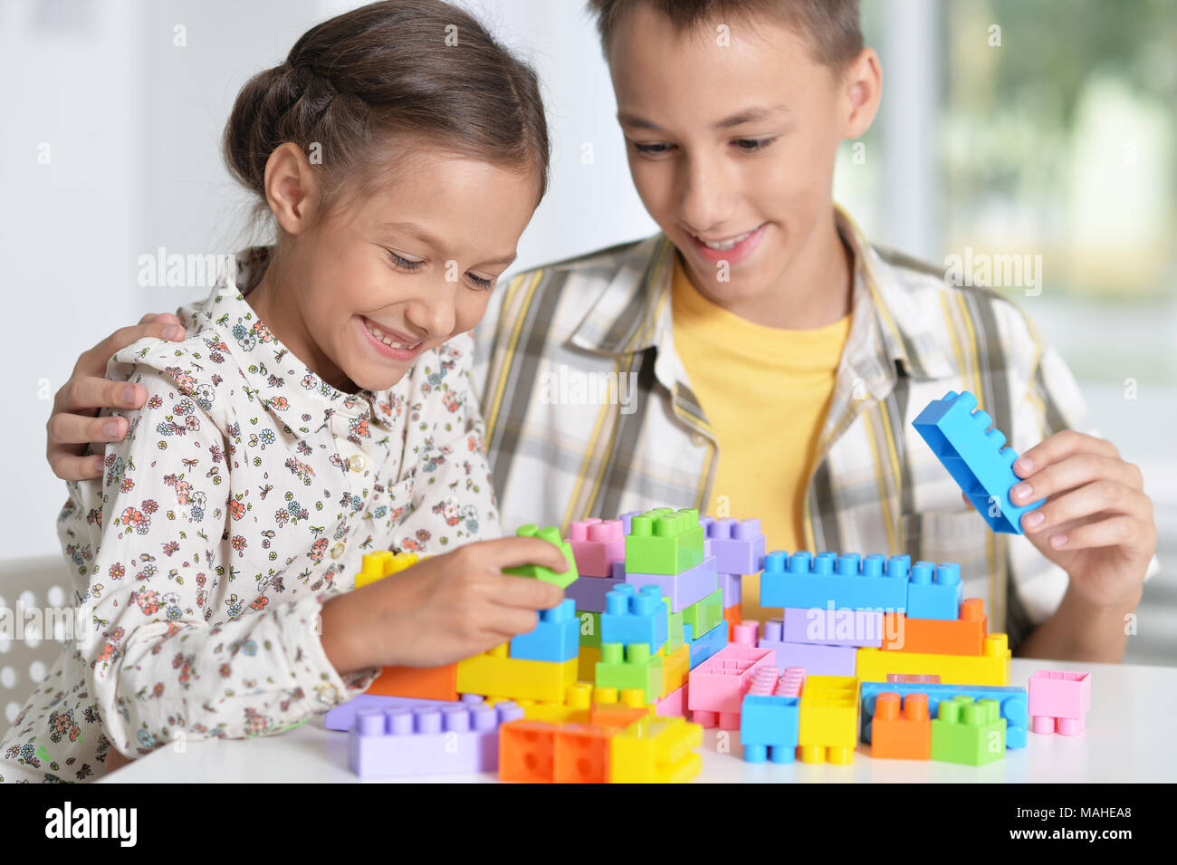Girl playing plastic blocks hi-res stock photography and images - Alamy